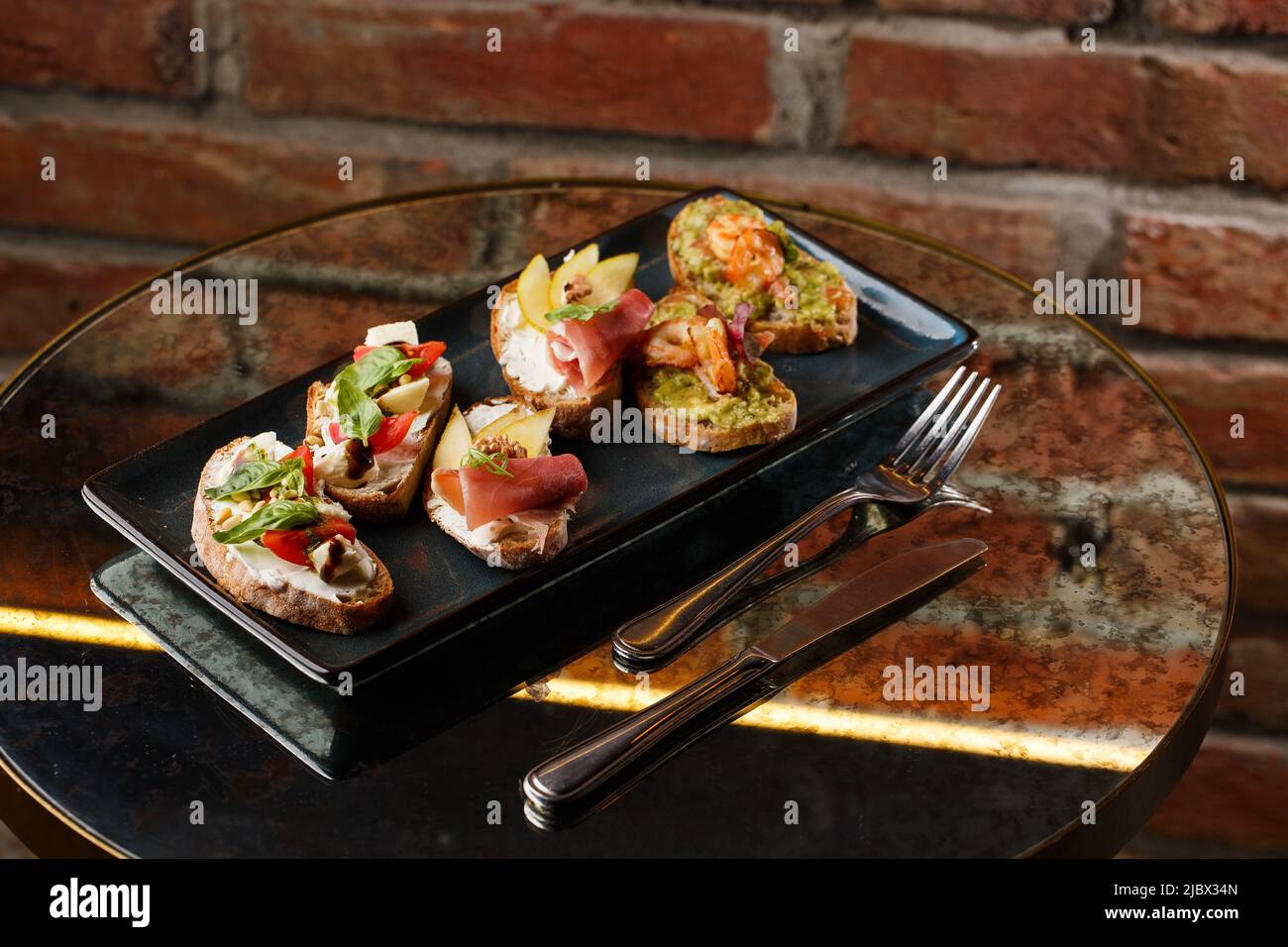 Bruschettas with vegetables. Start dishes with cherry tomatoes, avocado ...