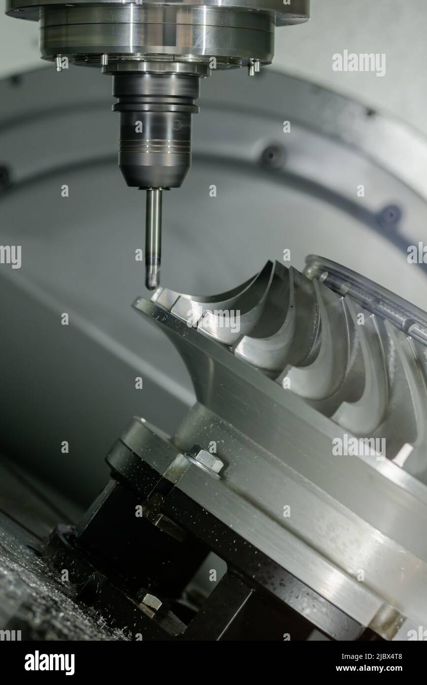 Close up: cnc turning milling machine cutting metal workpiece at ...