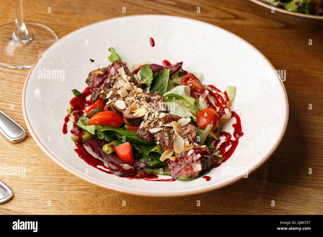 Salad with veal and tomatoes. Beef steak with raw vegetables mix side ...