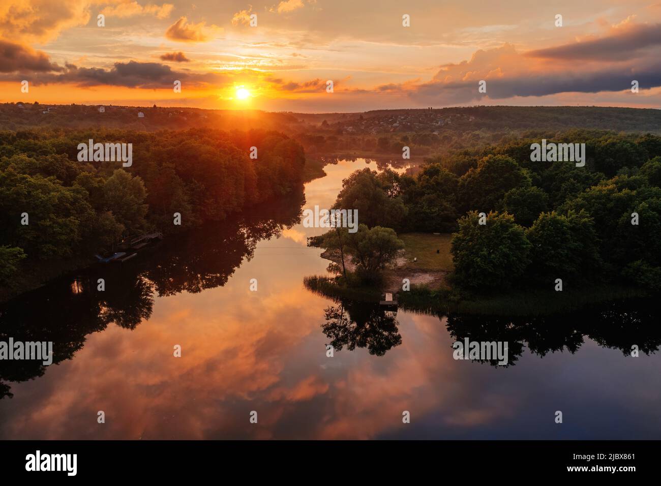 Sunset above the river in natural rural landscape Stock Photo - Alamy