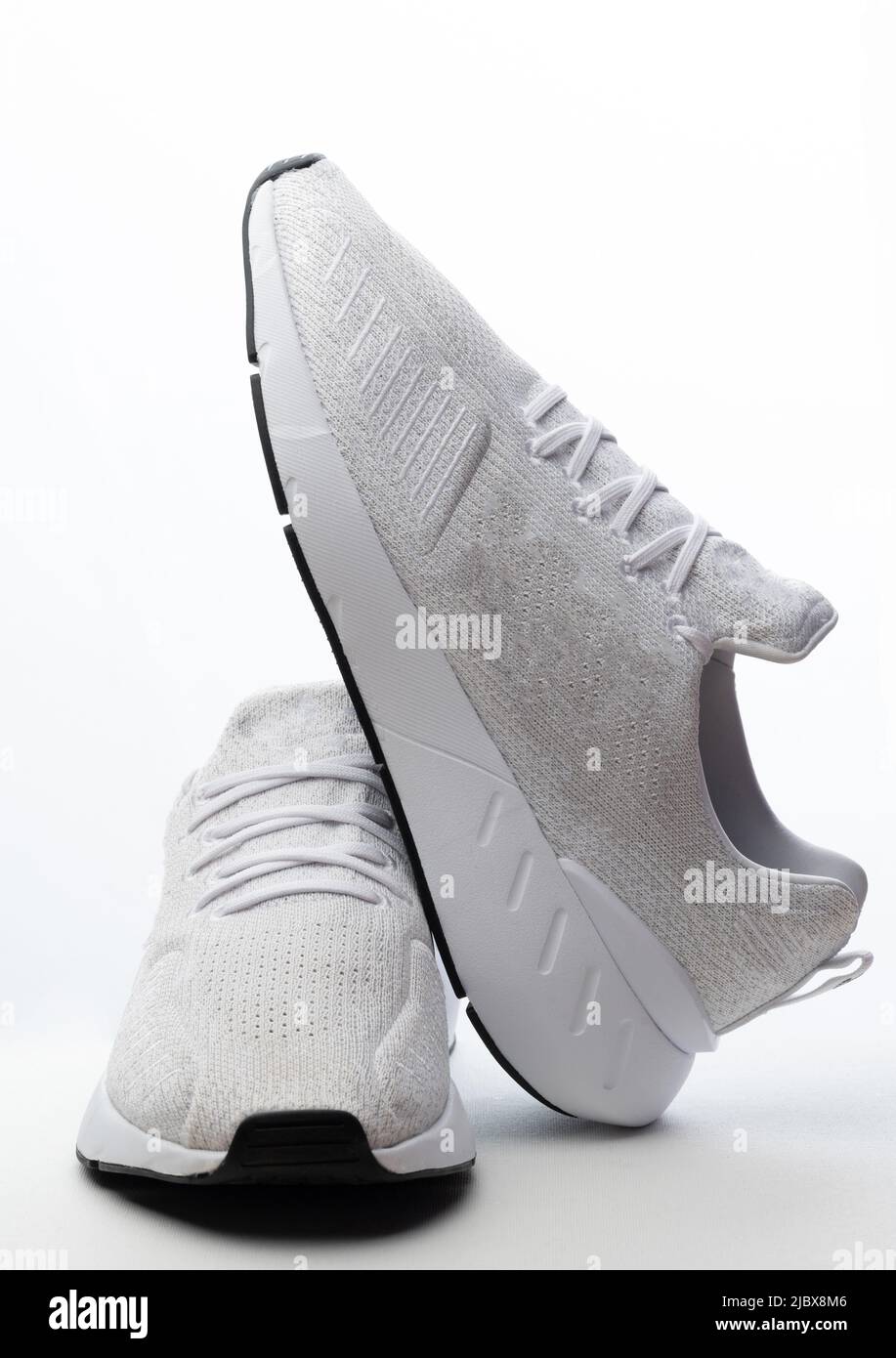 Clean pair of white sport shoes isolated on studio background Stock ...