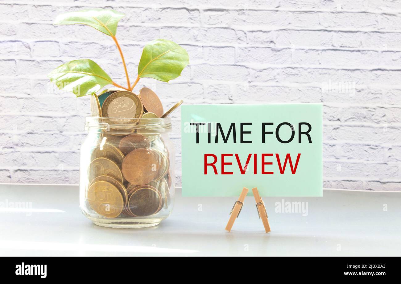 TIME TO REVIEW text on notepad with laptop on the white background ...