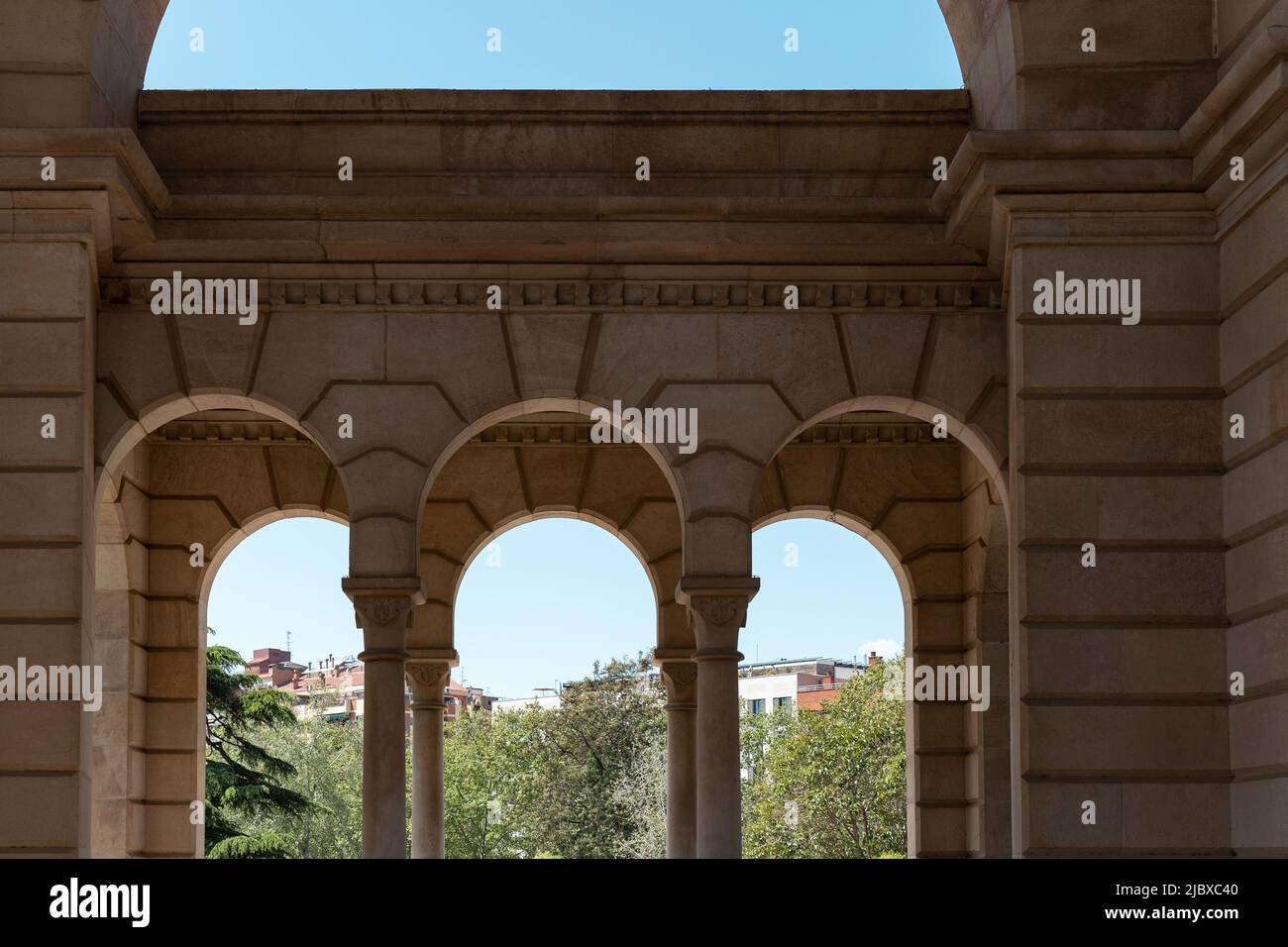 Arched stone columns with view of a town in the background. Wall of a ...
