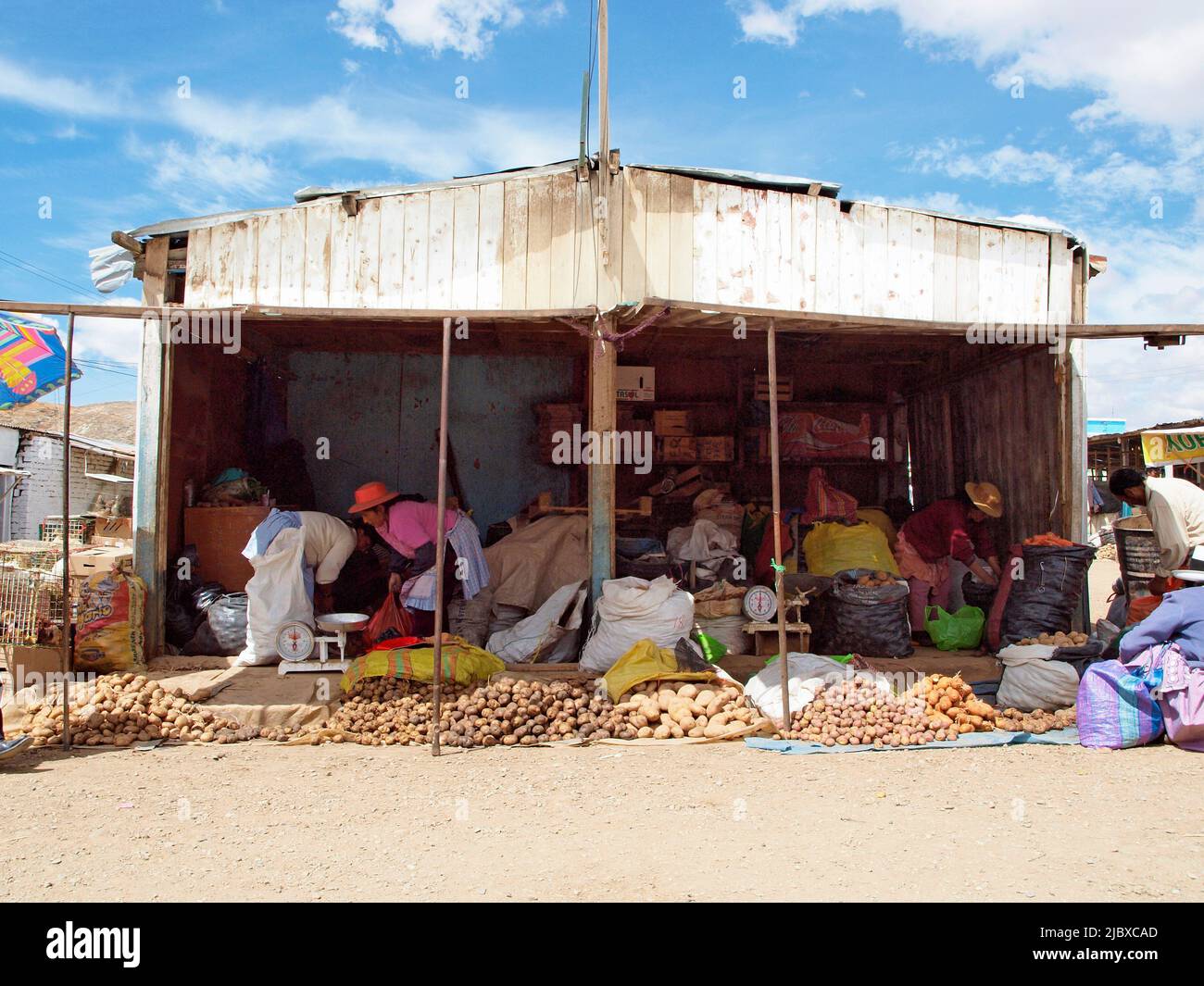 Buyers and sellers interacting at a rural indigenous potato market in ...