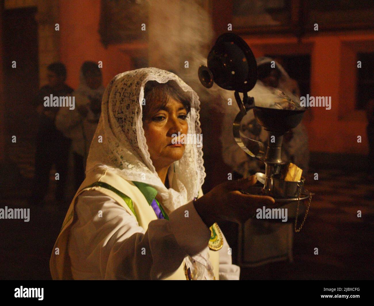 Female devotee carrying a incense burner on Friday of Sorrows. The ...