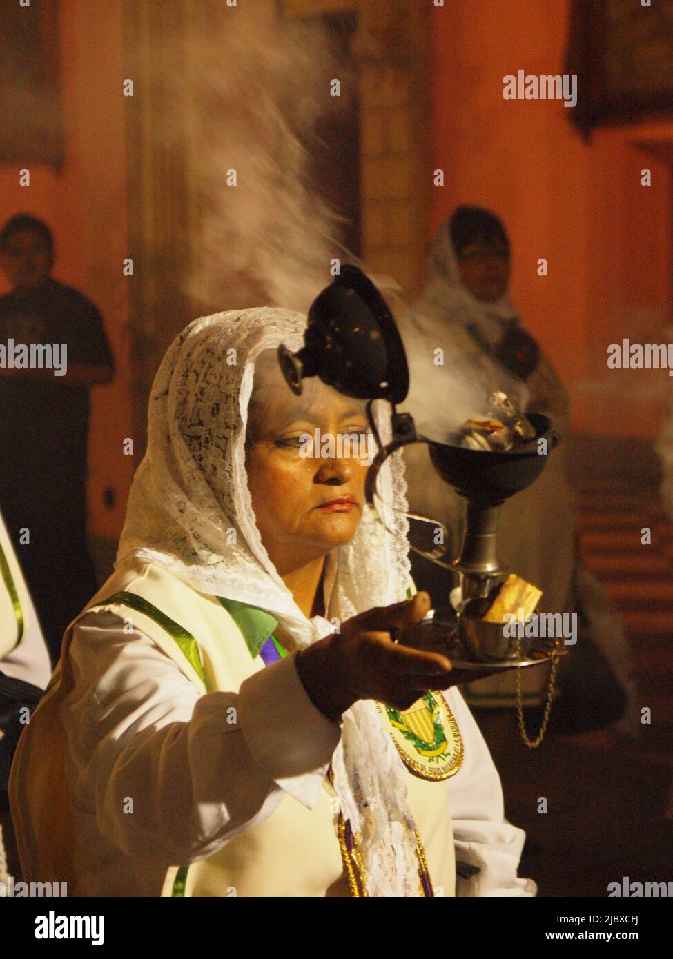 Female devotee carrying a incense burner on Friday of Sorrows. The ...