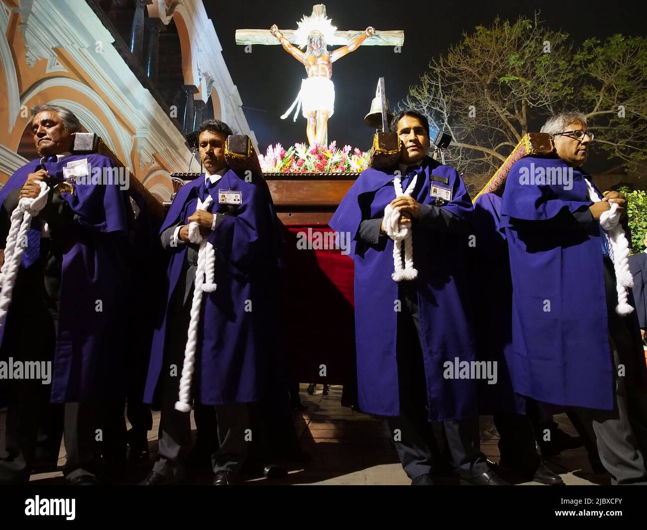Penitents carrying a religious litter with an image of Crucified Christ ...