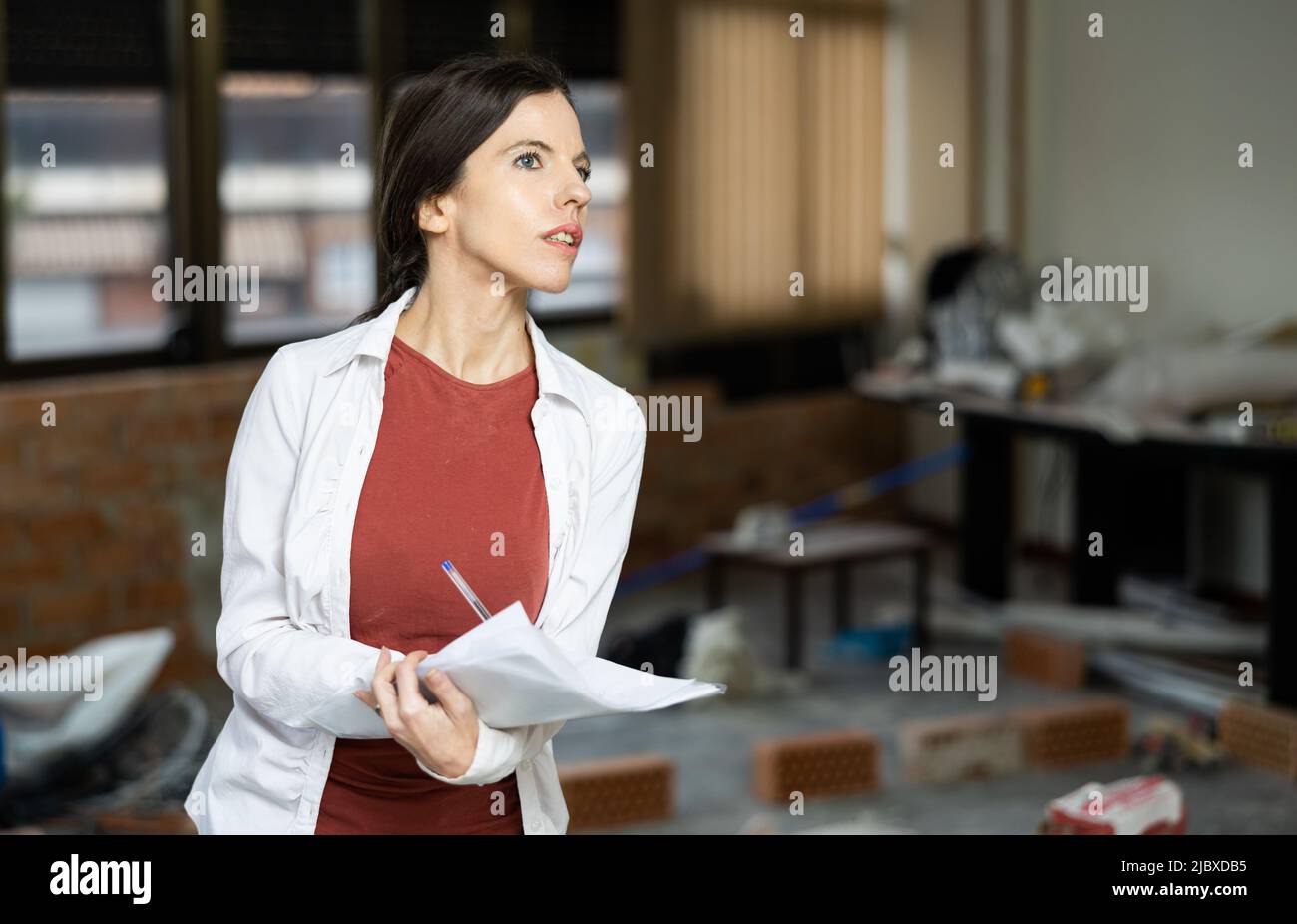 Architect woman checks according to the plan completed repair work ...