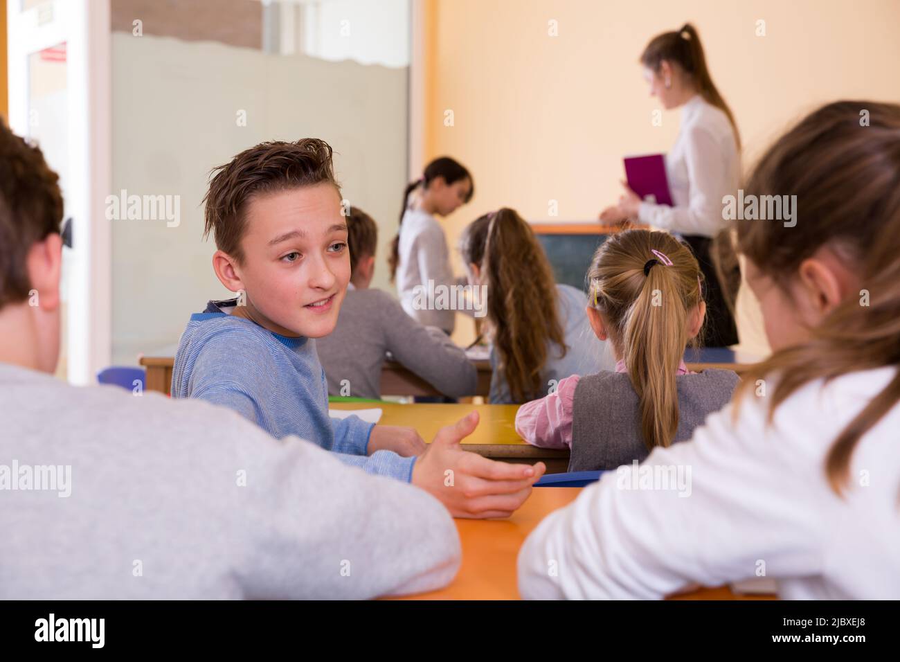 Pupils chattering at lesson Stock Photo - Alamy