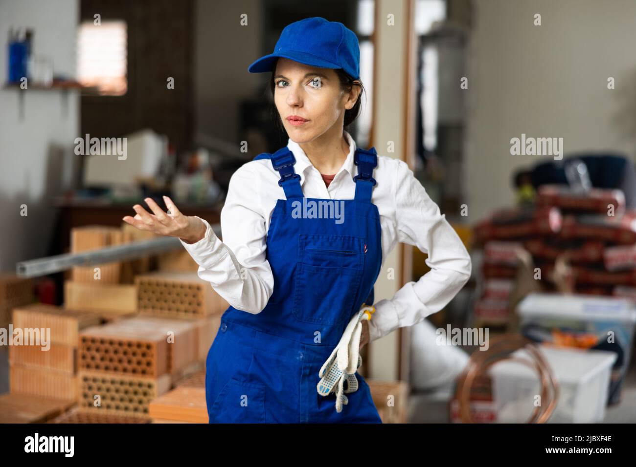 Woman construction worker posing inside house under renovation Stock ...