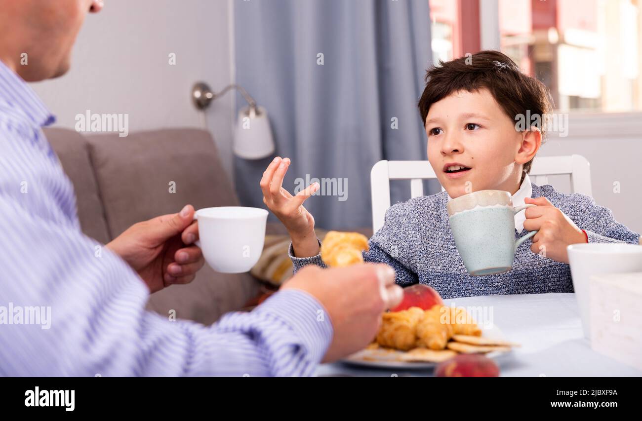 Happy boy chatting with dad Stock Photo - Alamy