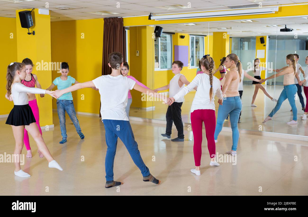 Children with teacher holding hands and dancing in dance school Stock ...