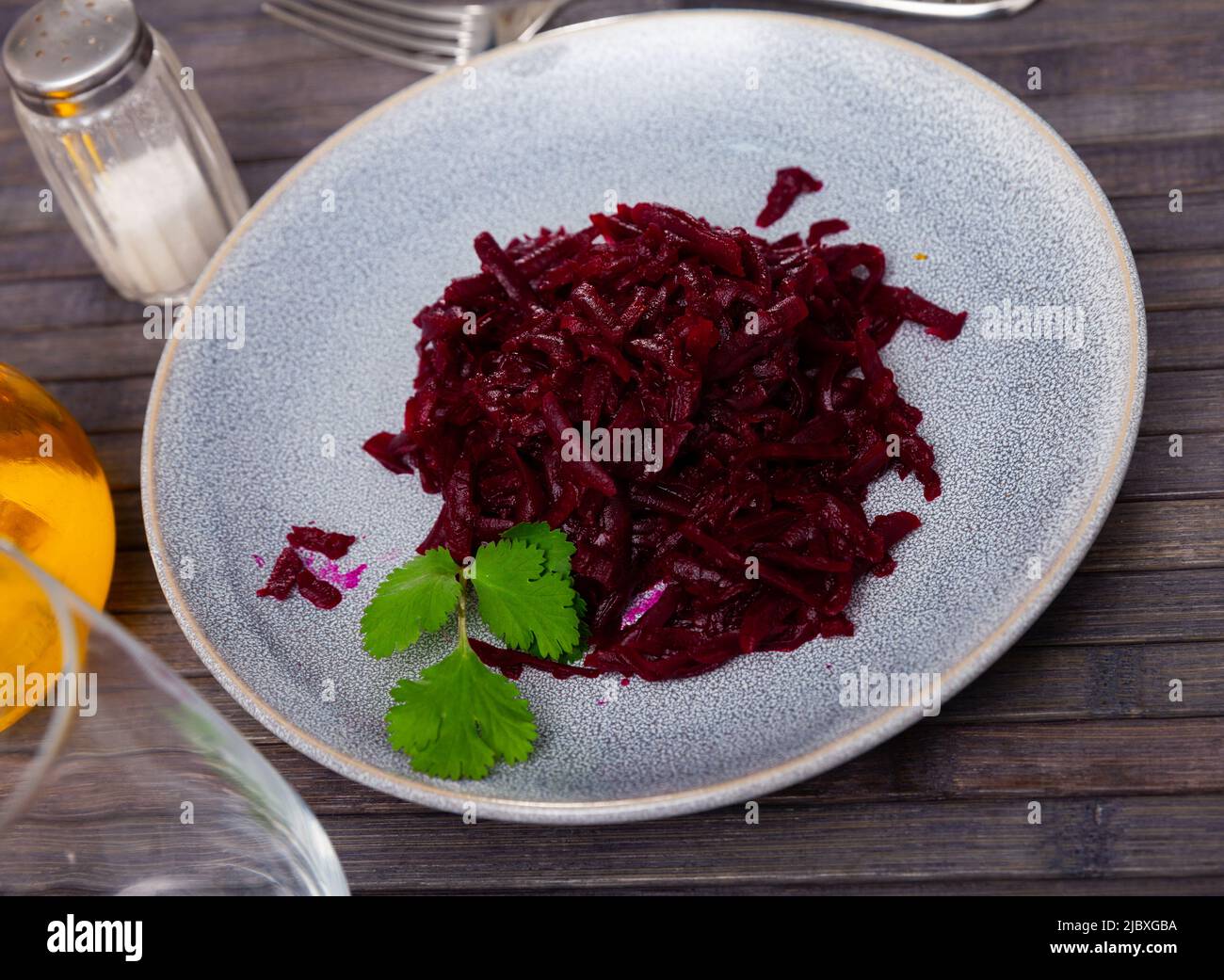 Salad of grated boiled beets with olive oil and greens Stock Photo - Alamy