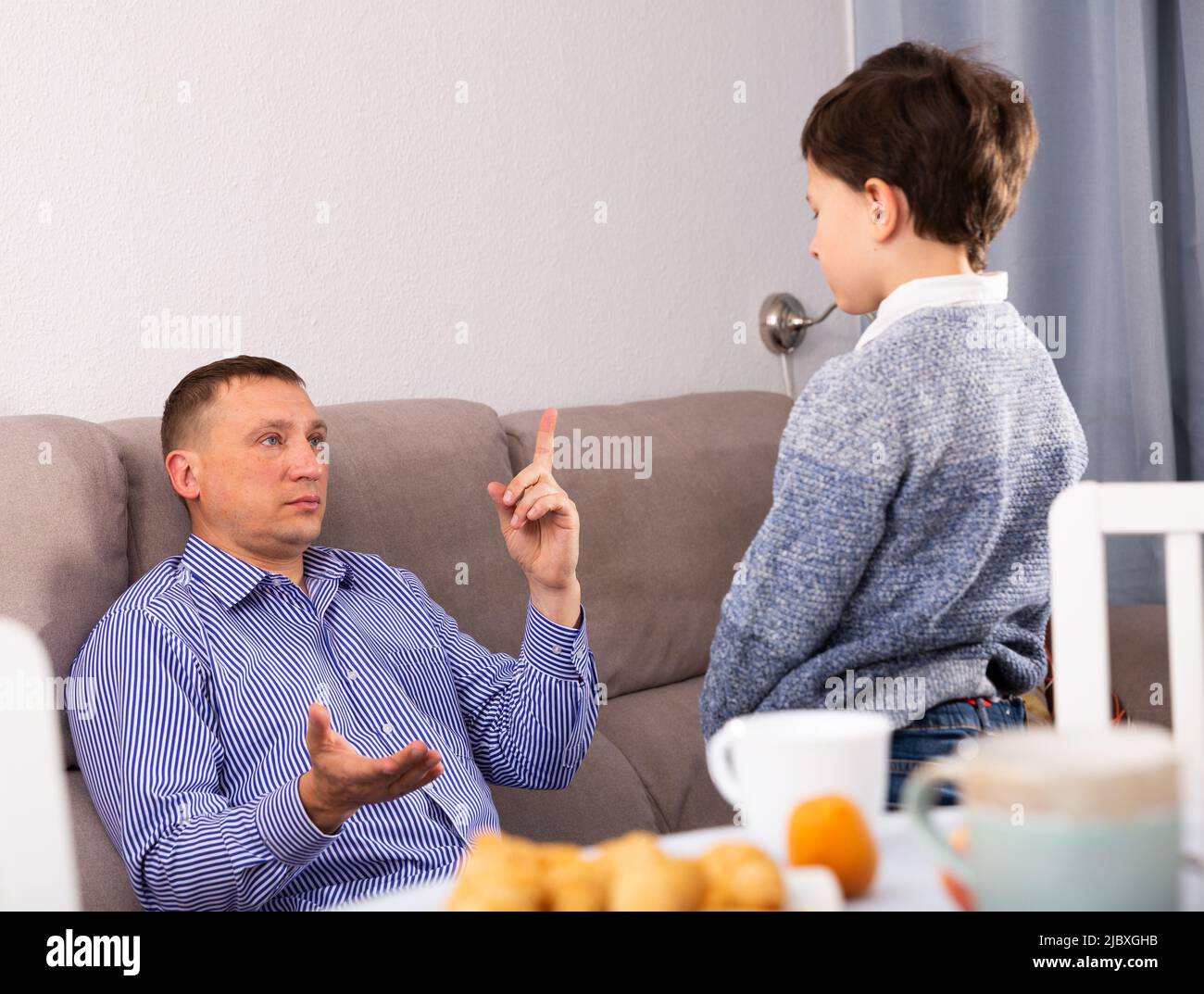 Worried father moralizing son Stock Photo - Alamy