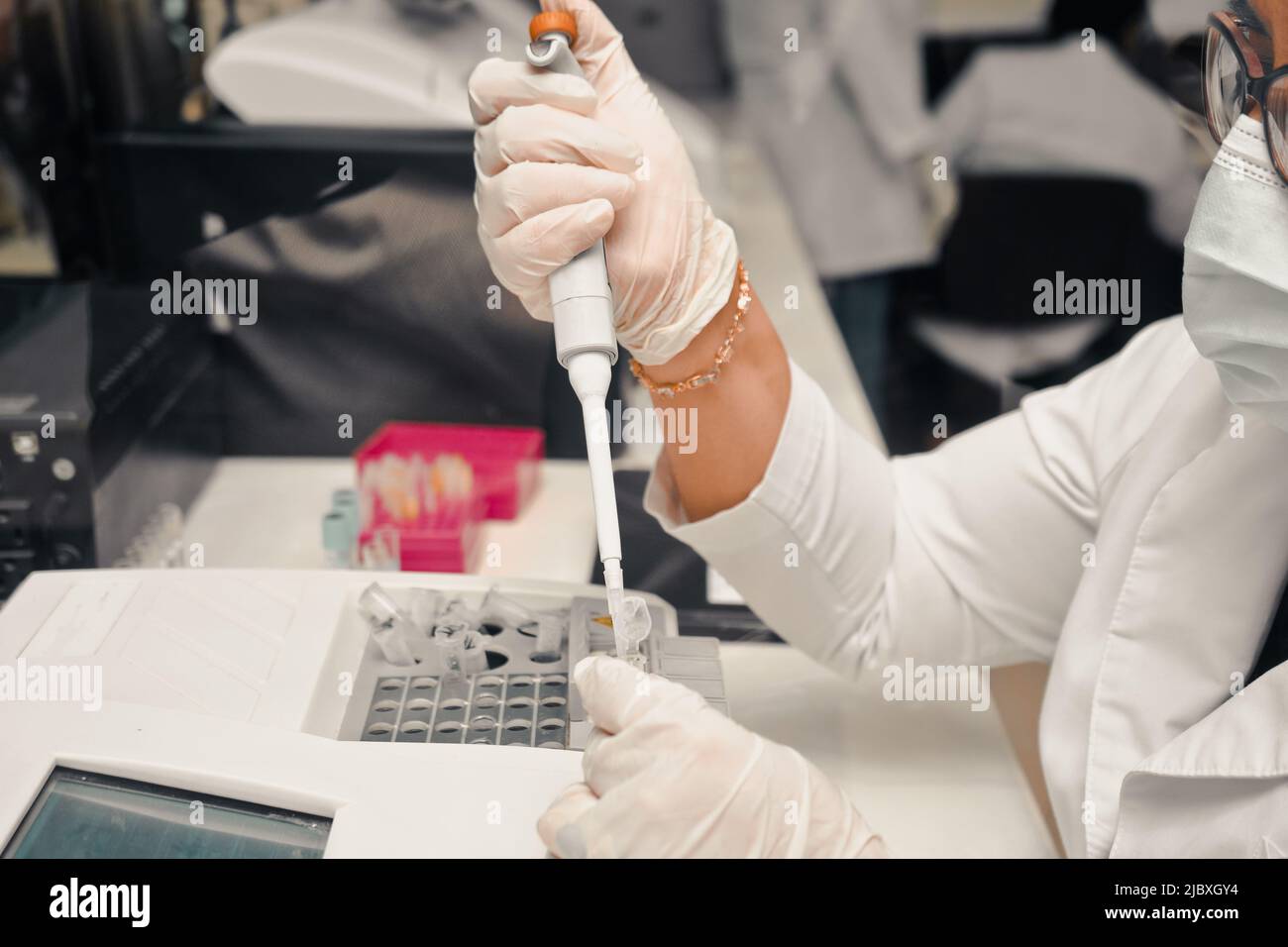 Operator filling medical samples with laboratory equipment in a ...
