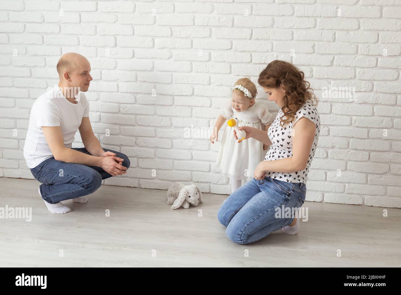 Baby child with hearing aids and cochlear implants plays with parents ...