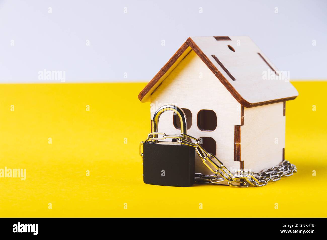 Housing arrest. Castle house. Small toy house and a chain with a lock ...