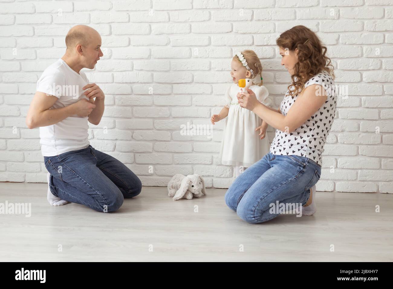 Baby child with hearing aids and cochlear implants plays with parents ...