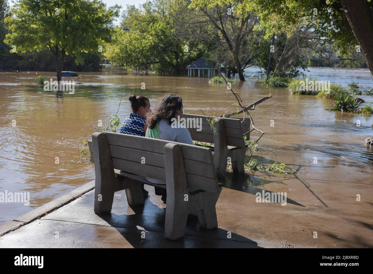 BRIDGEPORT, PA – September 2, 2021: People sit near the overflowing ...