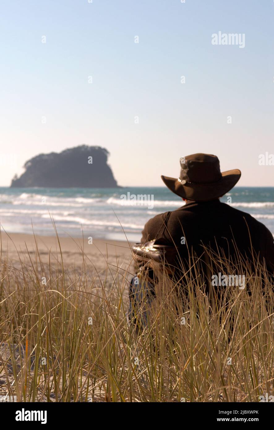Back view of a man wearing an akubra hat and shoes slung over his ...