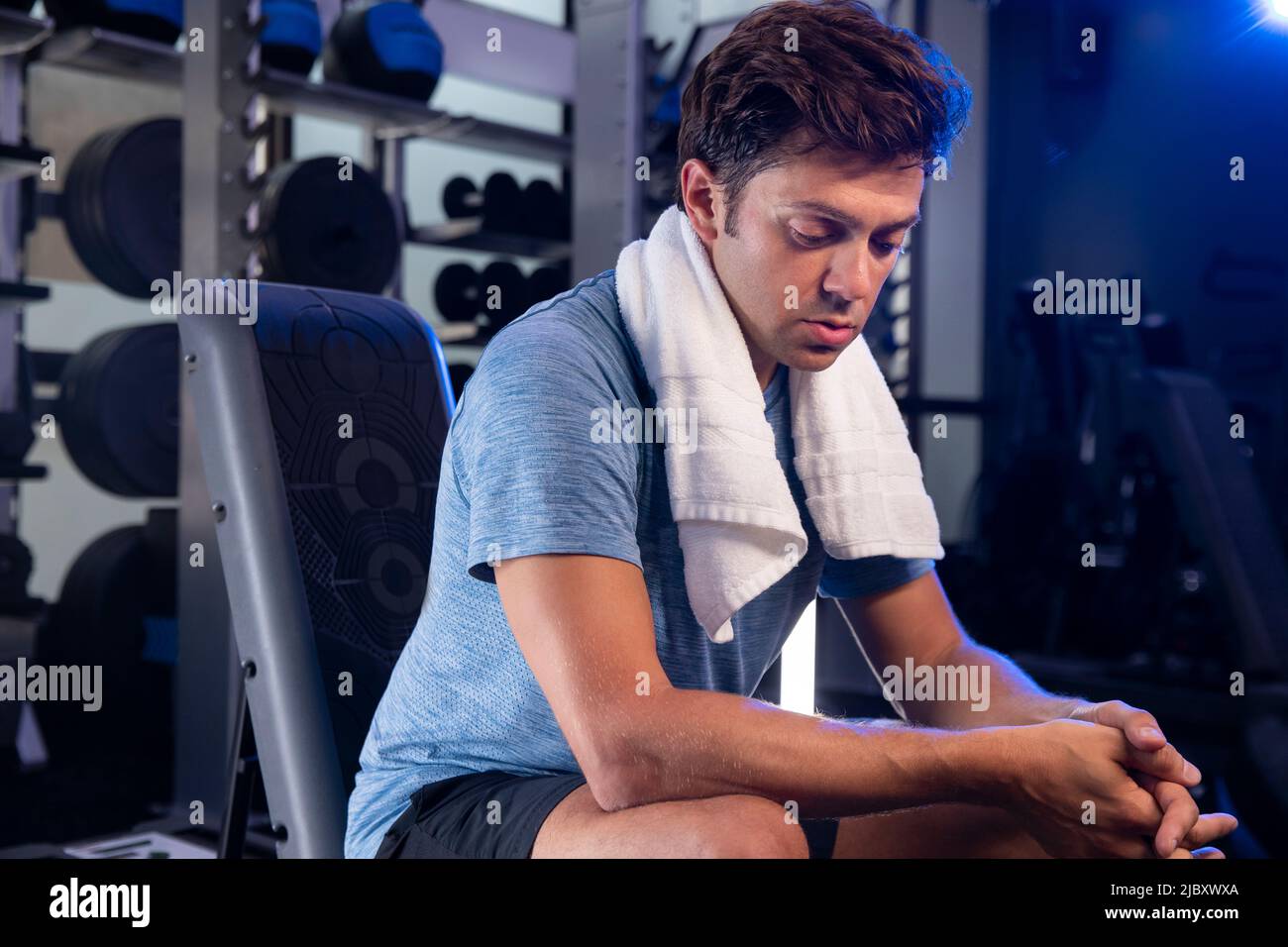 Young man cooling off after working out in gym Stock Photo - Alamy