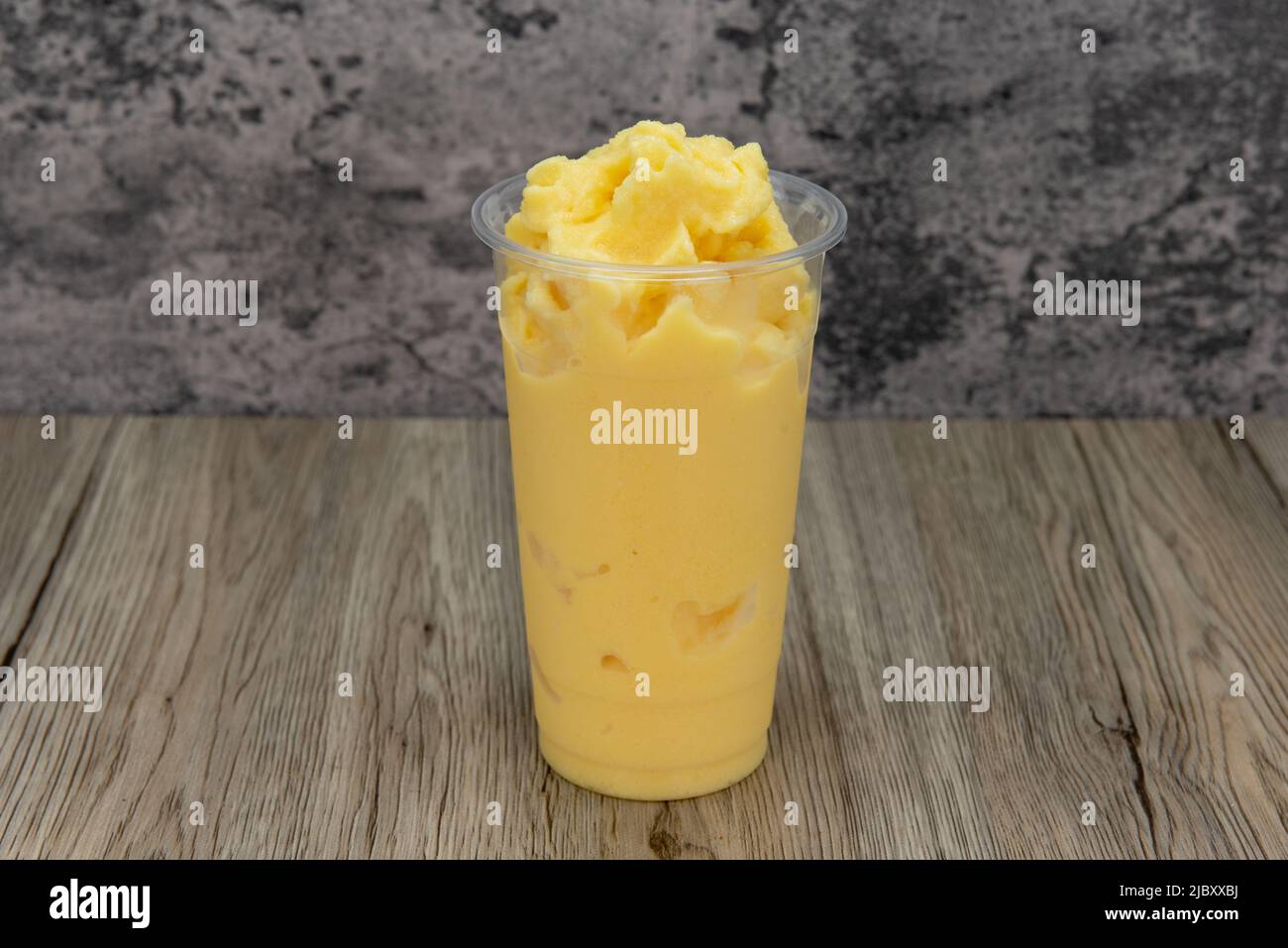 Tasty mango blended drink in a tall cup and ice cold for that thirsty ...