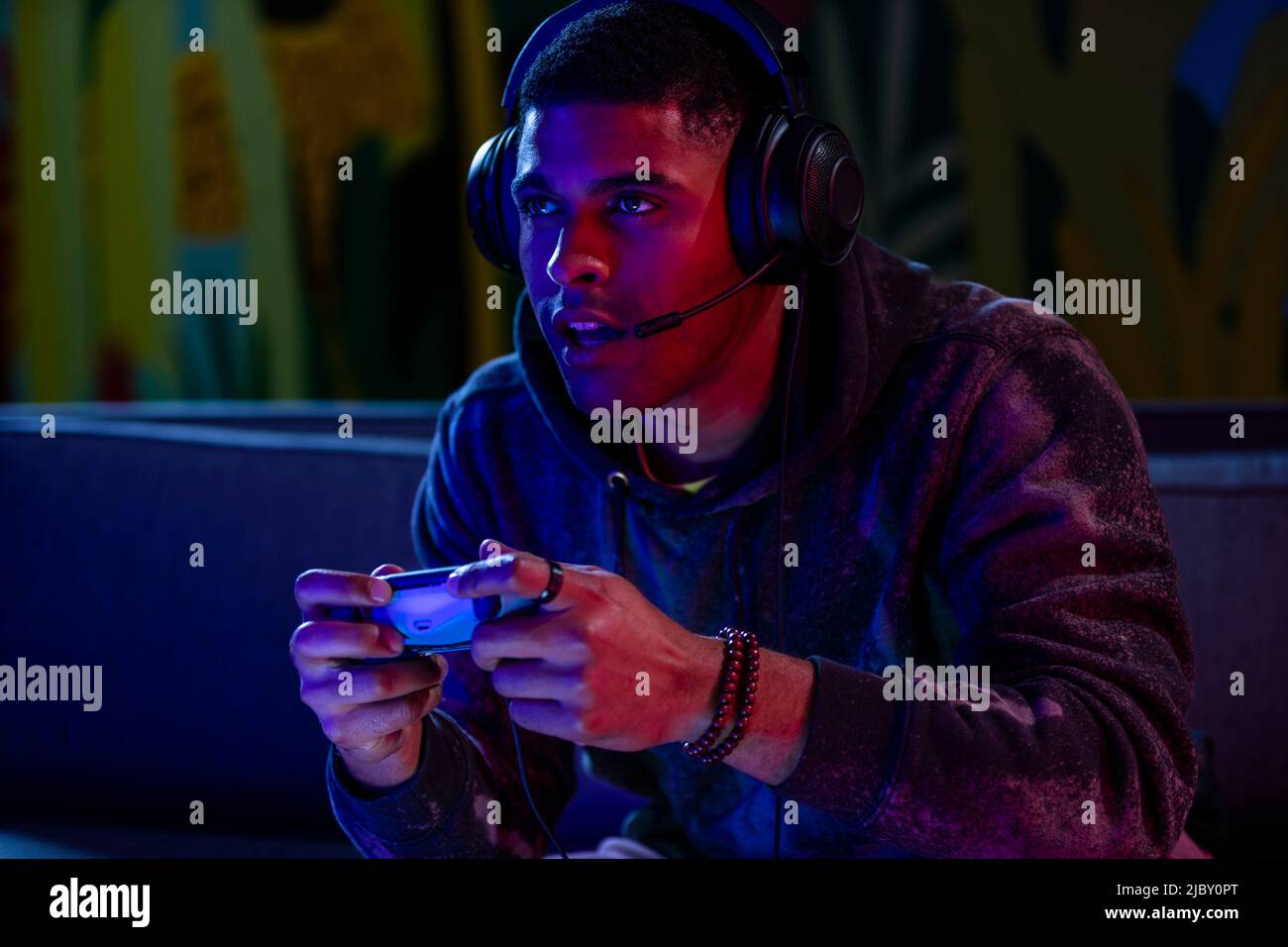 Young man playing video game in dark room at night Stock Photo - Alamy