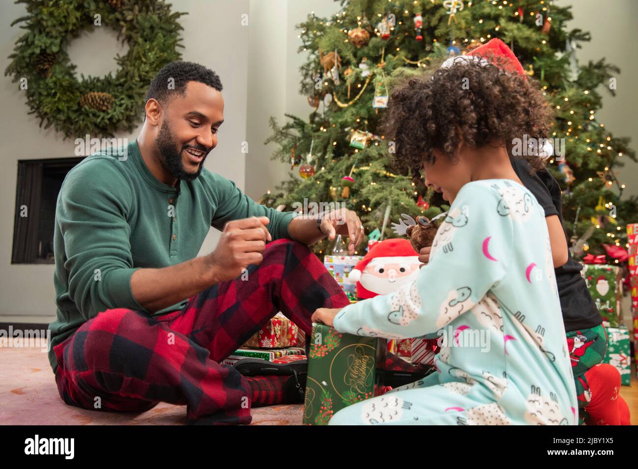 Young single father celebrating Christmas with his two children Stock ...