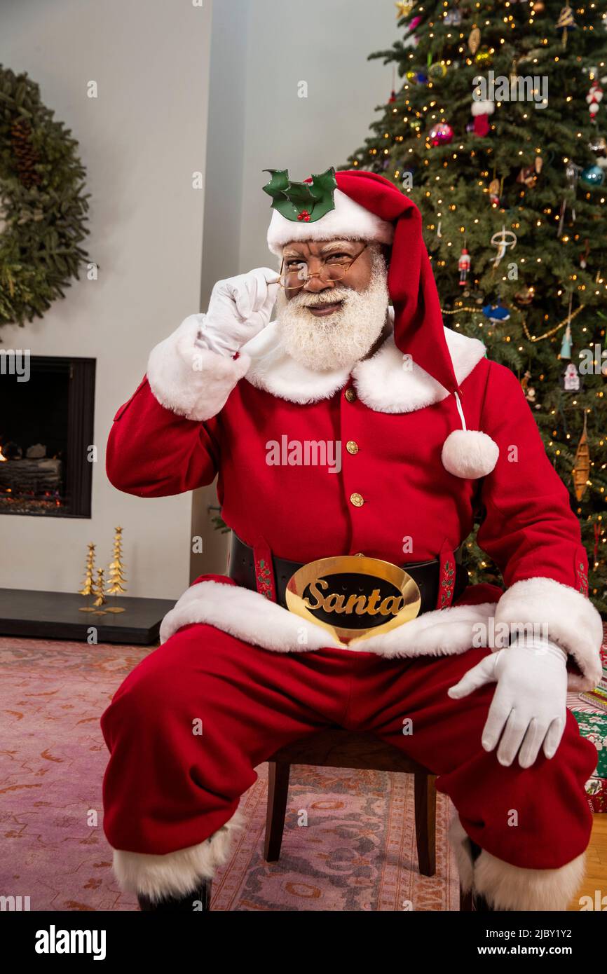 Jolly portrait of Black Santa Claus character looking into camera ...
