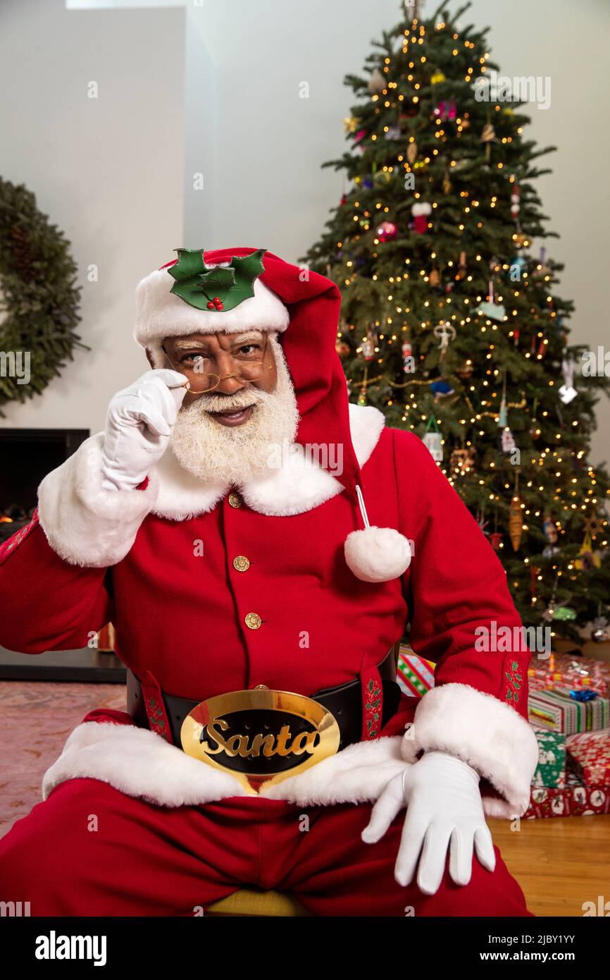 African American Santa Claus against Christmas background Stock Photo ...