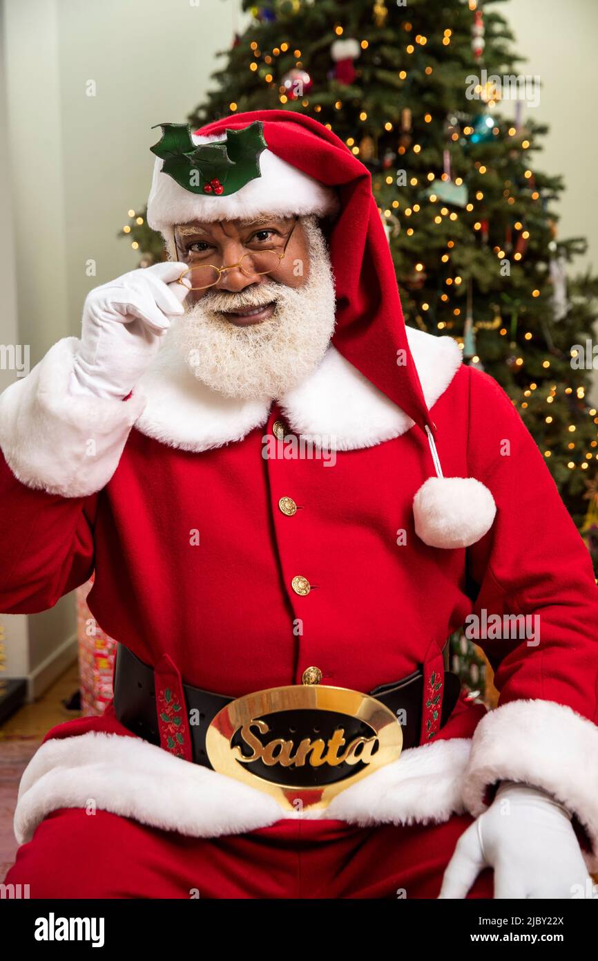 Portrait of Black Santa Claus looking into camera with happy smile ...