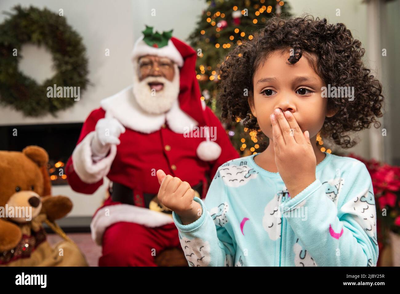 Little girl standing in living room with a surprised expression ...