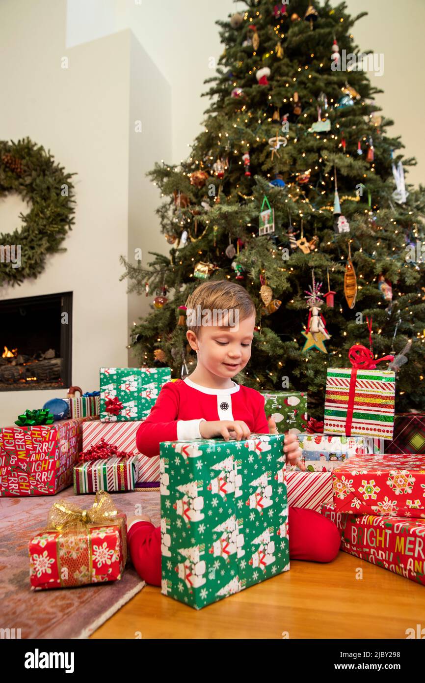 Happy boy opening presents on Christmas morning Stock Photo - Alamy