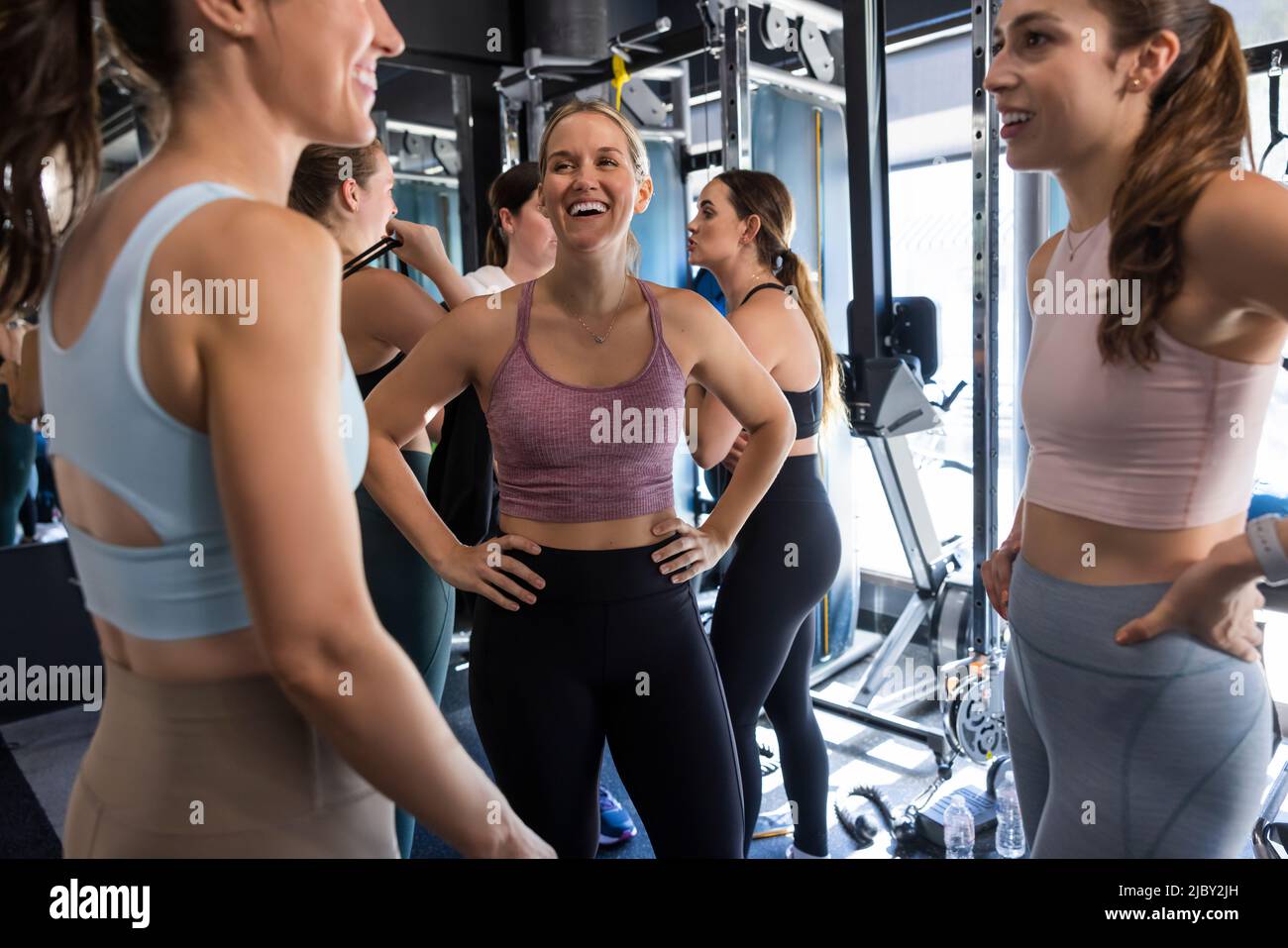 Smiling group of women taking a break in between workouts during a ...