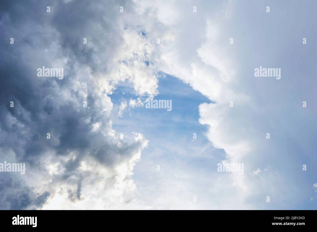 Clouds parting and blue sky breaking through the gap Stock Photo - Alamy