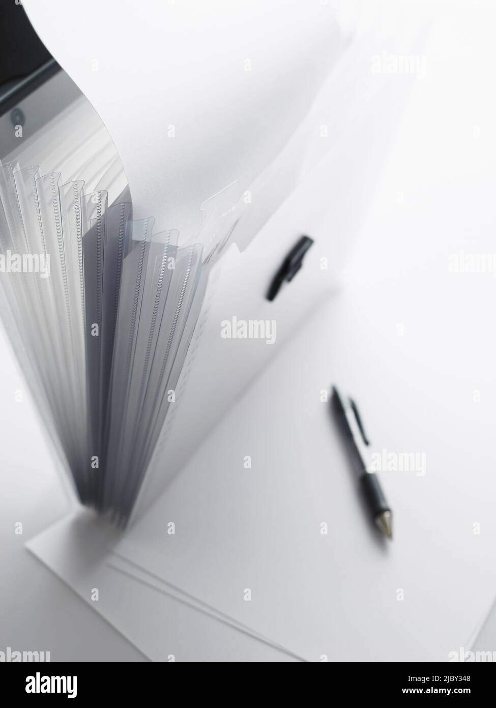 Clear plastic expanding concertina file and pen on desk Stock Photo - Alamy