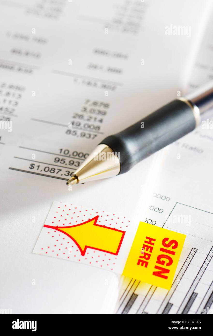 Balance sheet with 'sign here' sticker and pen Stock Photo - Alamy
