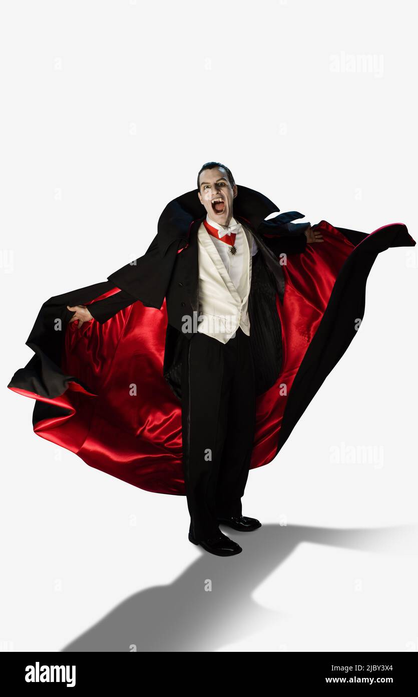 A vampire against a white background holding his arms out at camera ...