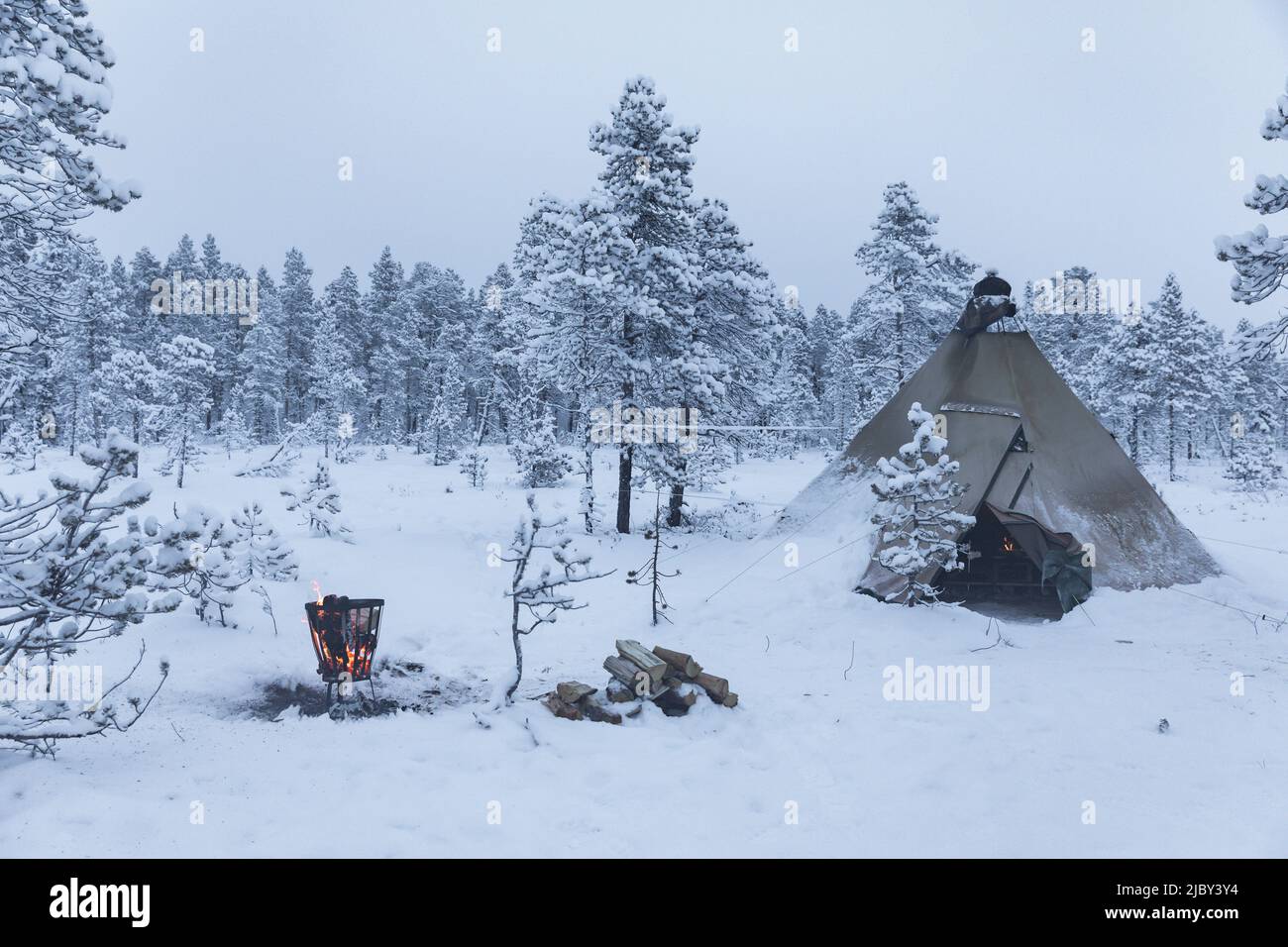 Camping teepee tent and firepit. Winter scene in Swedish Lapland Stock ...