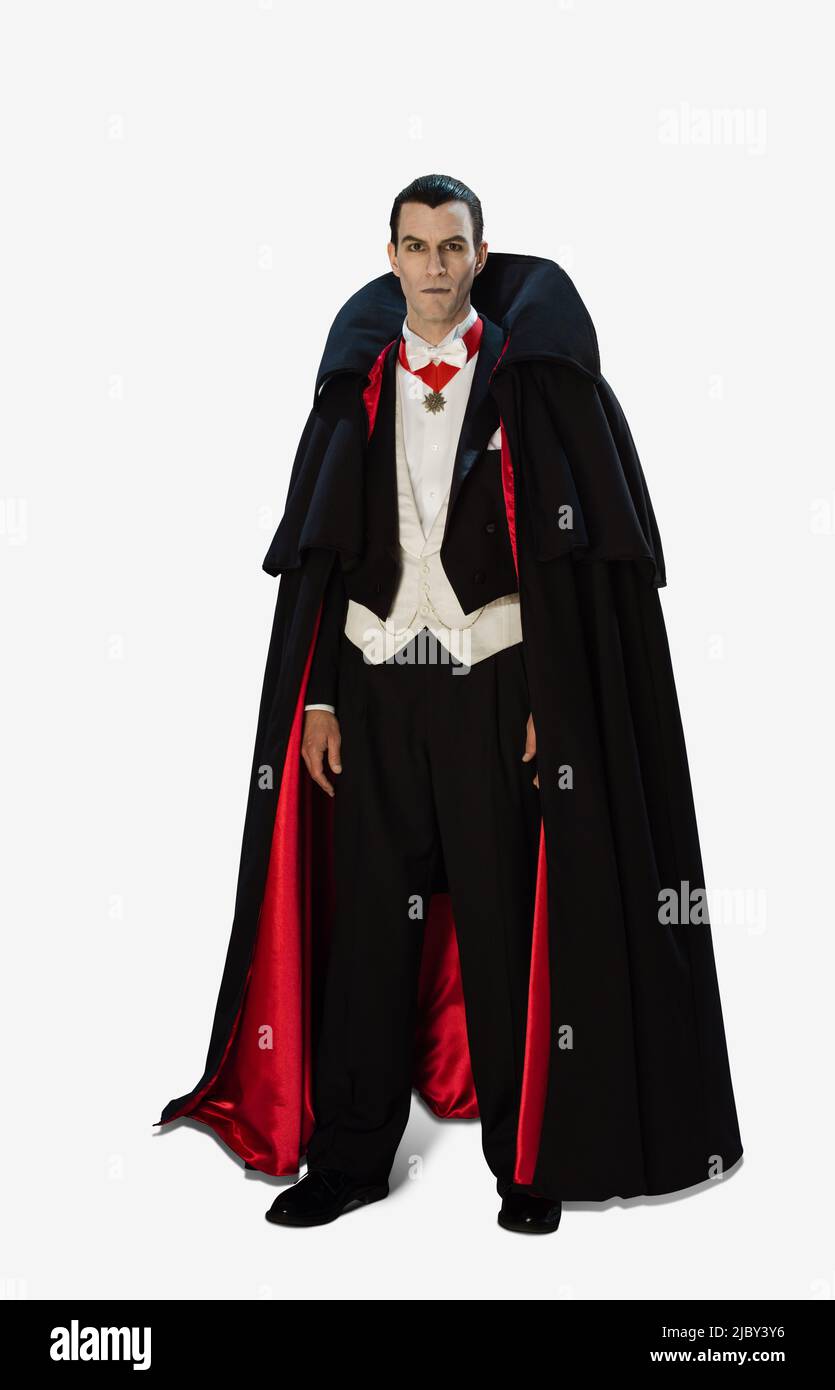 Full length portrait of a man dressed up as a vampire looking directly ...