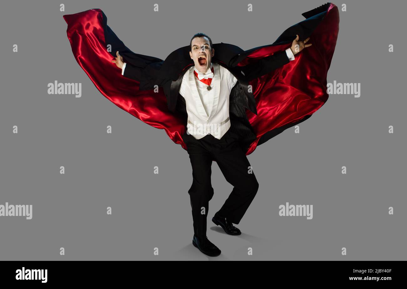 Themed portrait of a vampire on a gray background lunging towards ...