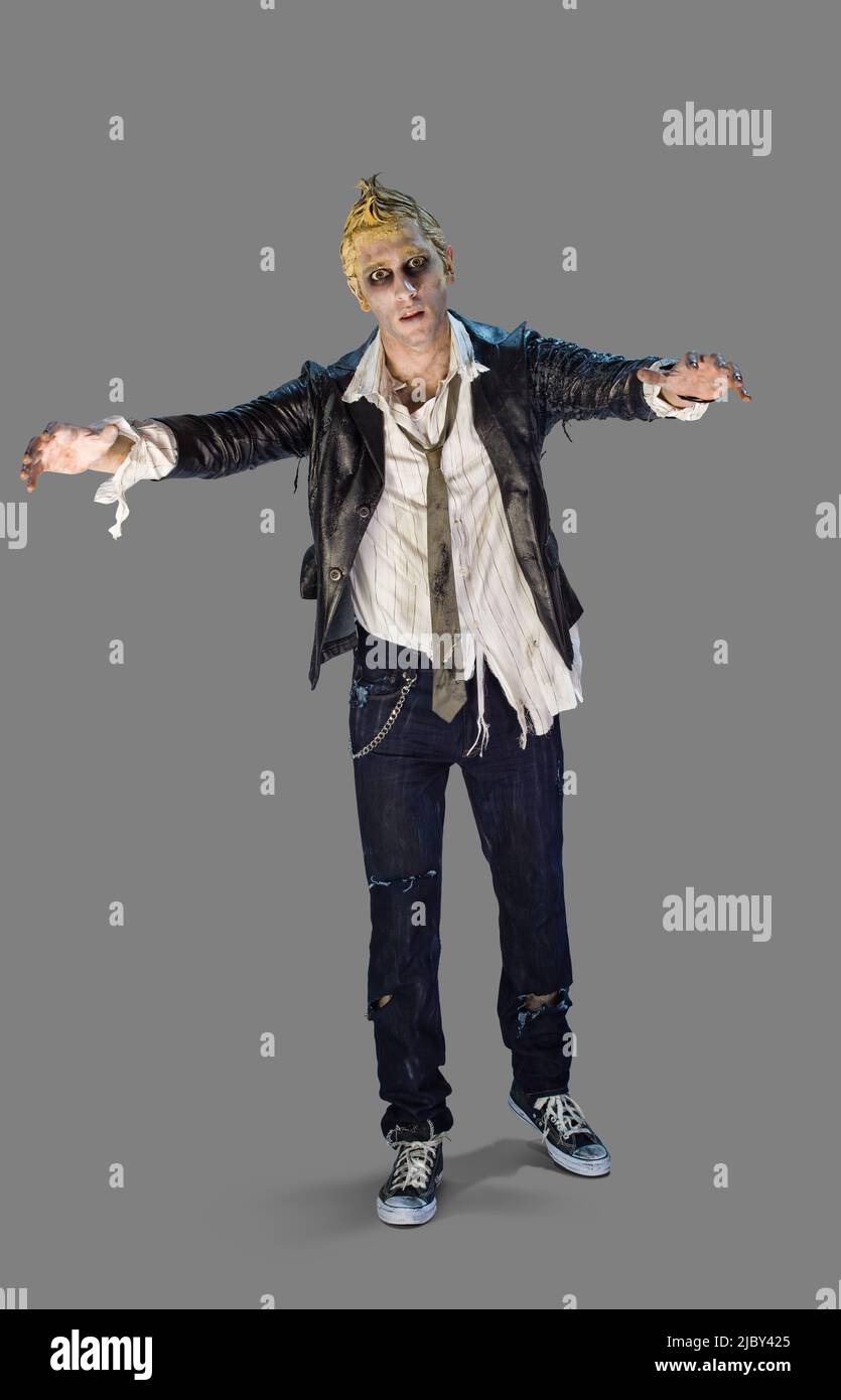 Full length portrait of a zombie looking into camera with a mindless ...