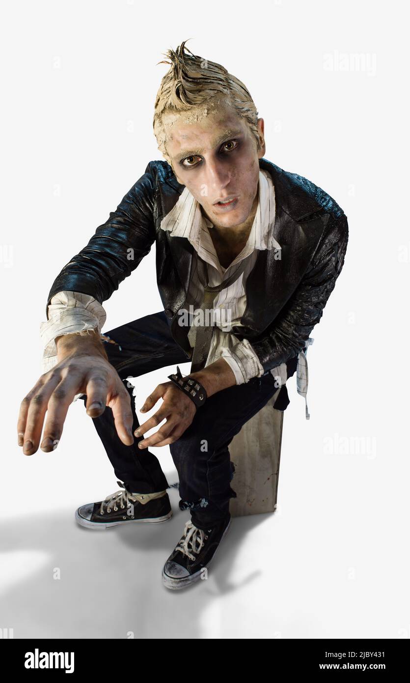 Wide close up shot of man dressed up in a zombie costume reaching out ...