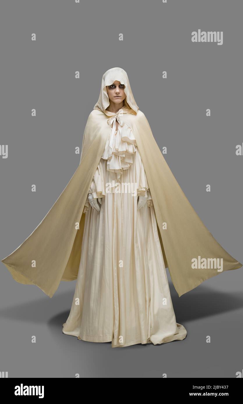 Woman dressed as ghost with black circles around her eyes looking into ...