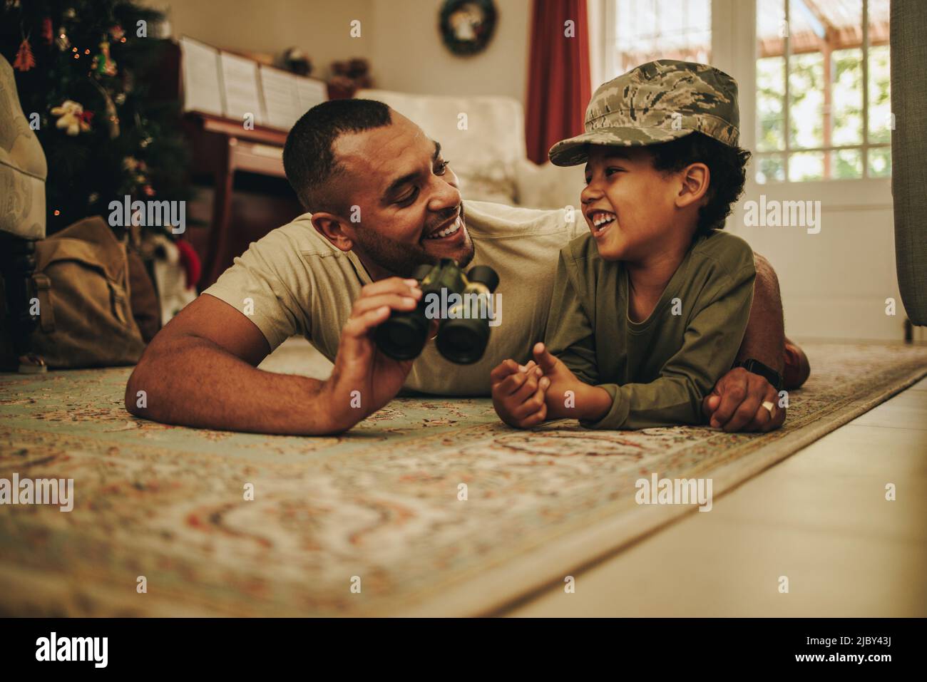 Father and son bonding at Christmas. Happy military dad spending the ...