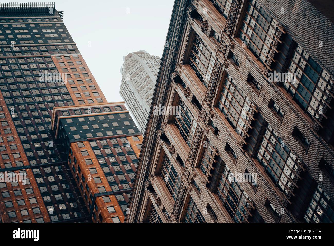 Two brick high rise buildings in Manhattan in front of a skyscraper on ...