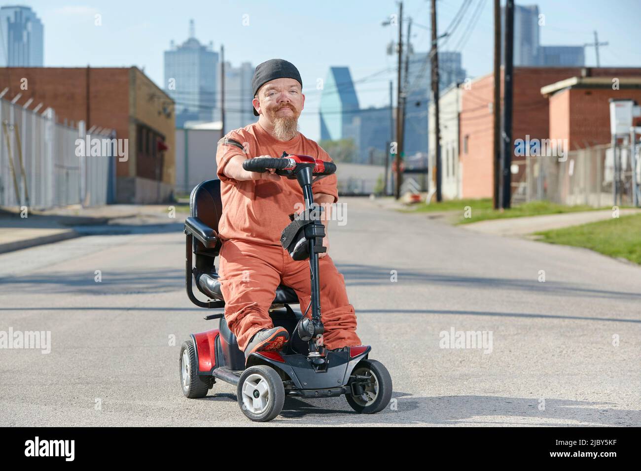 Portrait of male dwarf in the street in Texas looking into camera with ...