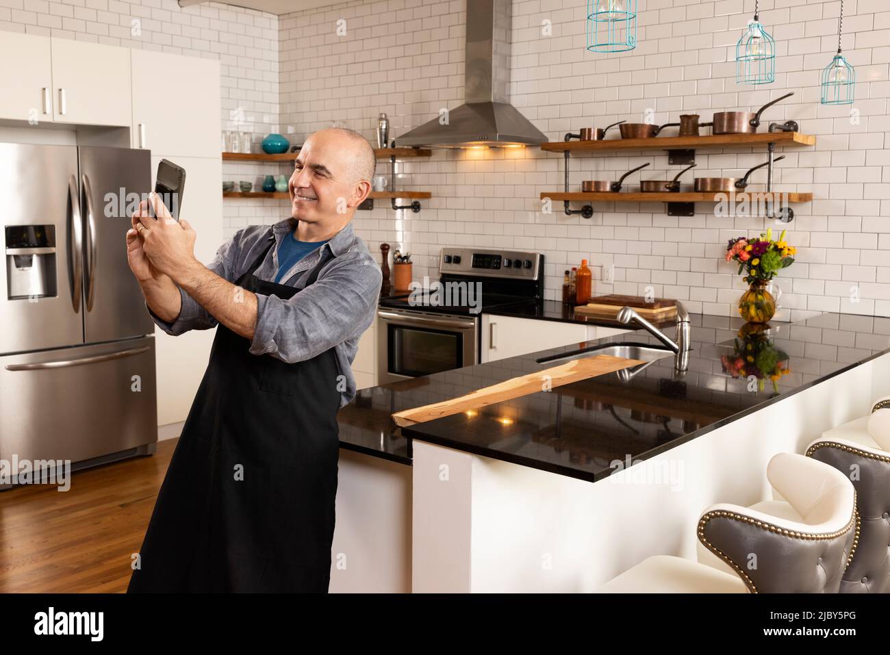 Man wearing apron cooking hi-res stock photography and images - Alamy