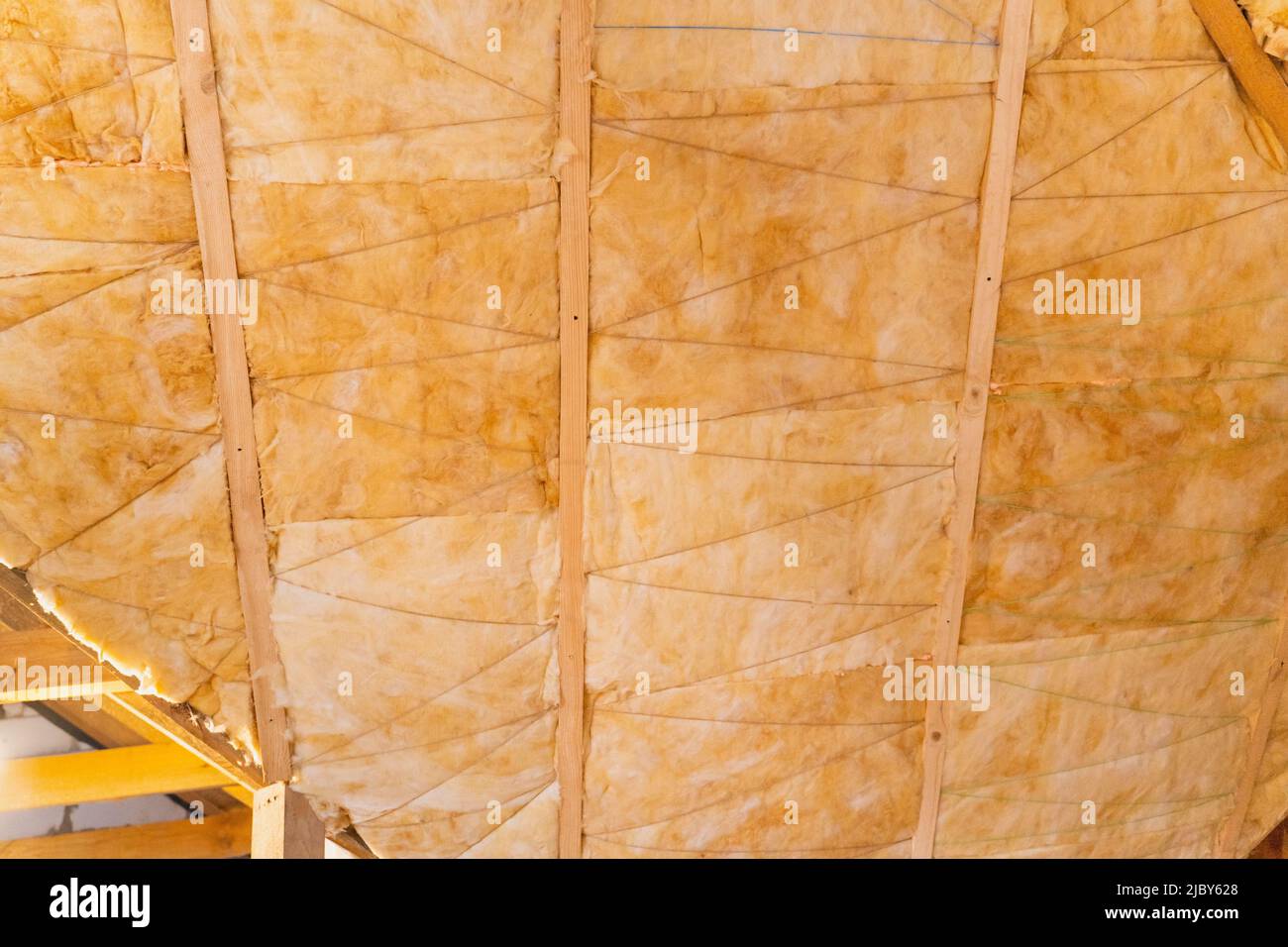 The roof is insulated with yellow glass wool. Insulation lining with ...