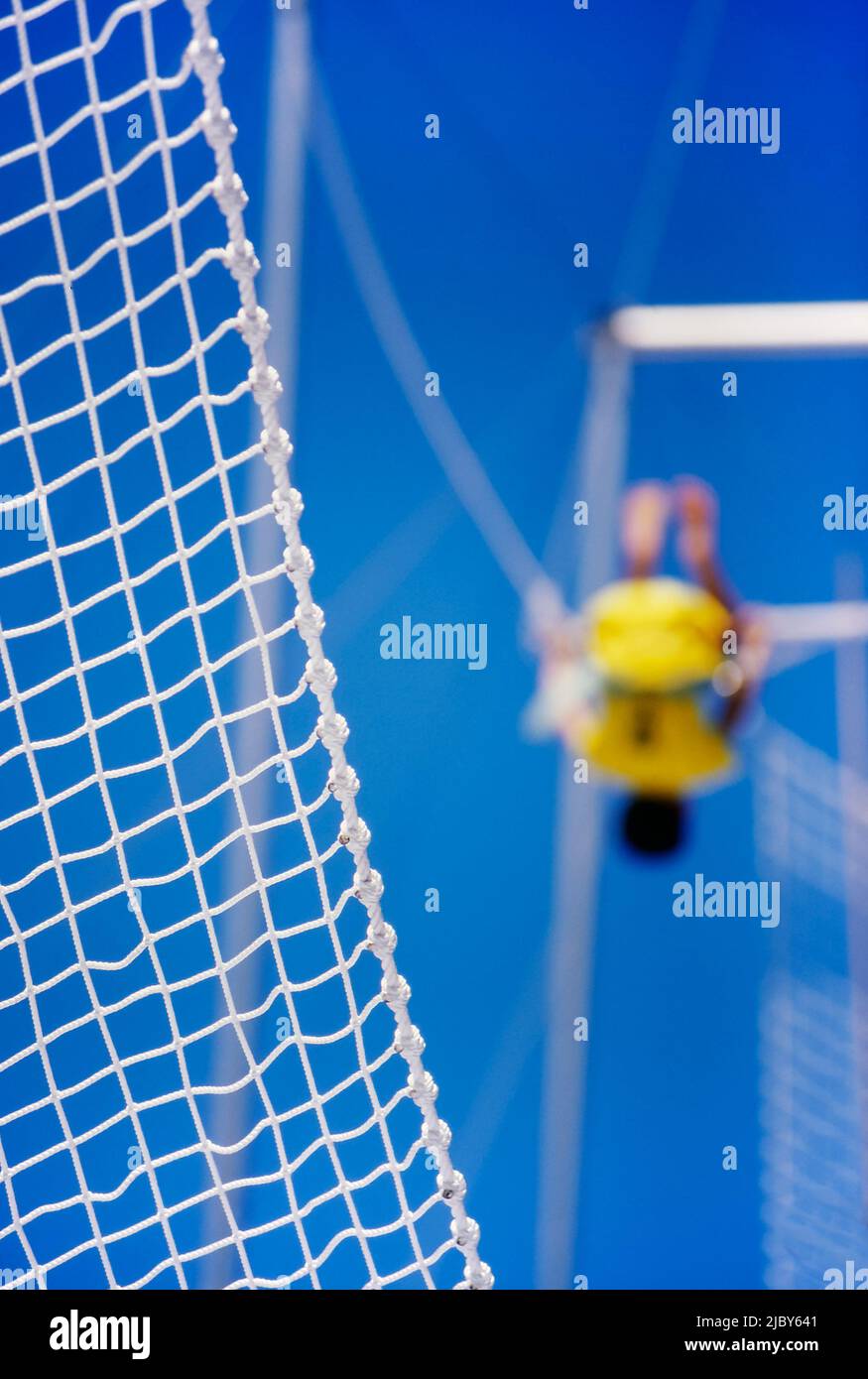 Trapeeze artist tumbling in the air Stock Photo - Alamy